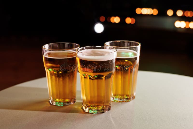 A Trio of Beer Glasses on a White Table Stock Photo - Image of pilsner ...