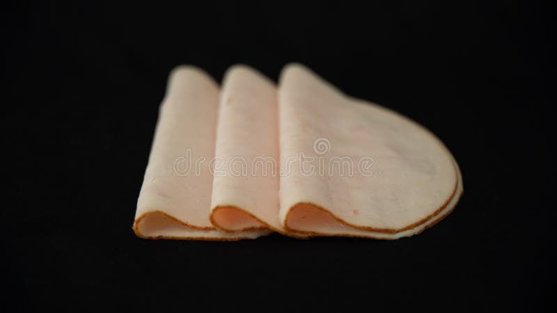 Trio of Poultry Ham Slice, Folded in Half, on a Black Background Stock ...