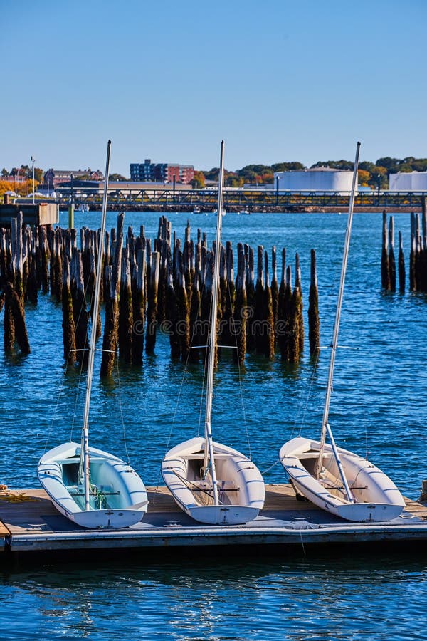 Trio of Three Small Boats on Dock with Old Pilings in Background Stock ...