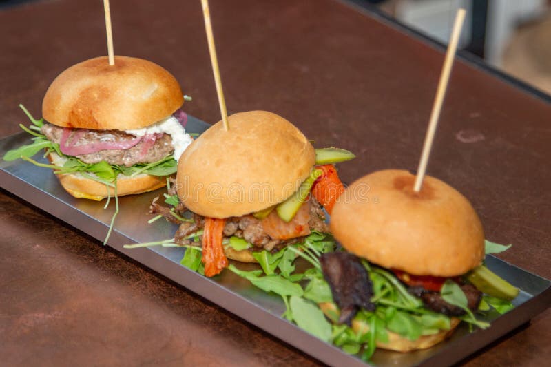 Trio of various sliders stock image. Image of burgers - 297494327