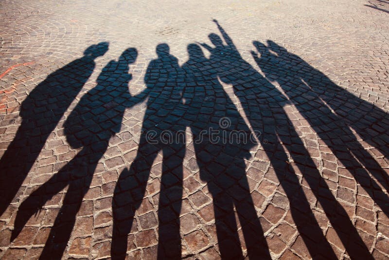Shadows of Friends Holding and Raising Hands Together Stock Image ...