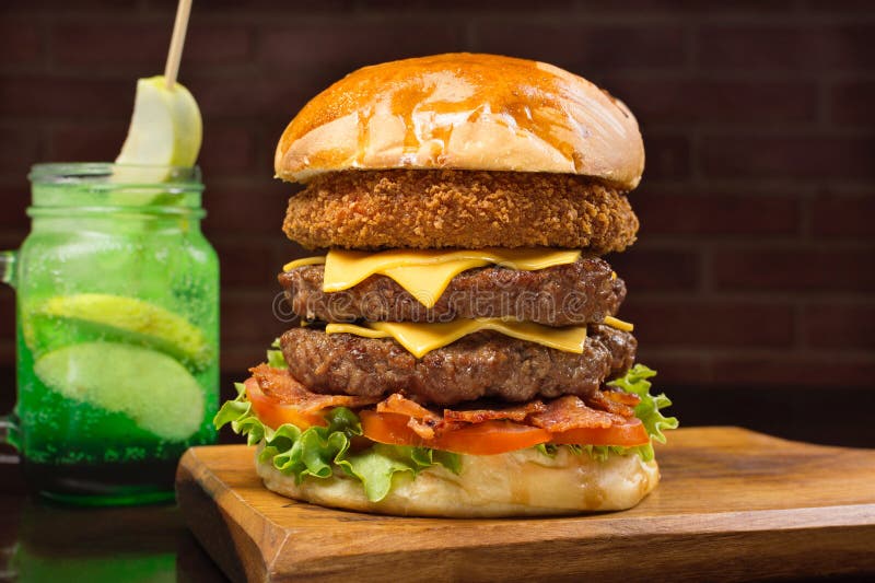 Triple Burger in a Wood Table Stock Image - Image of cheese, salad ...