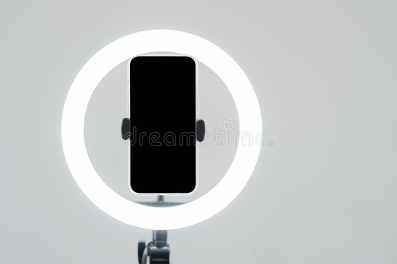 Tripod with Ring Light and Smartphone with Black Screen Over White ...