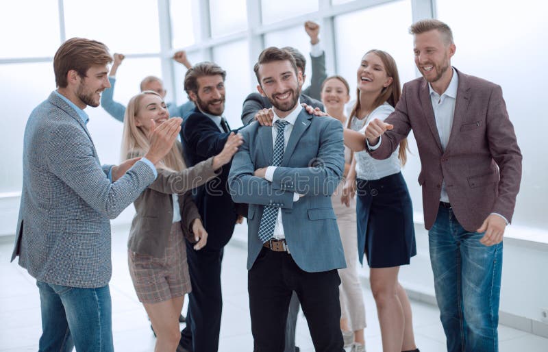 Triumphant Group of Staff Congratulating Their Leader Stock Photo ...