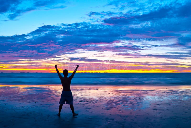 Triumphant Man at Sunset - Horizontal Stock Image - Image of nature ...