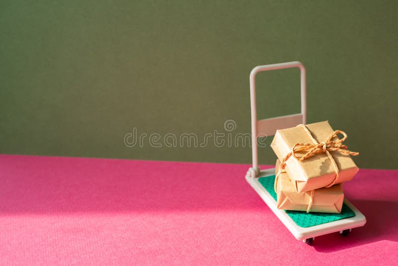 Trolley Cart with Gift Boxes on Pink and Khaki Green Background. Parcel ...