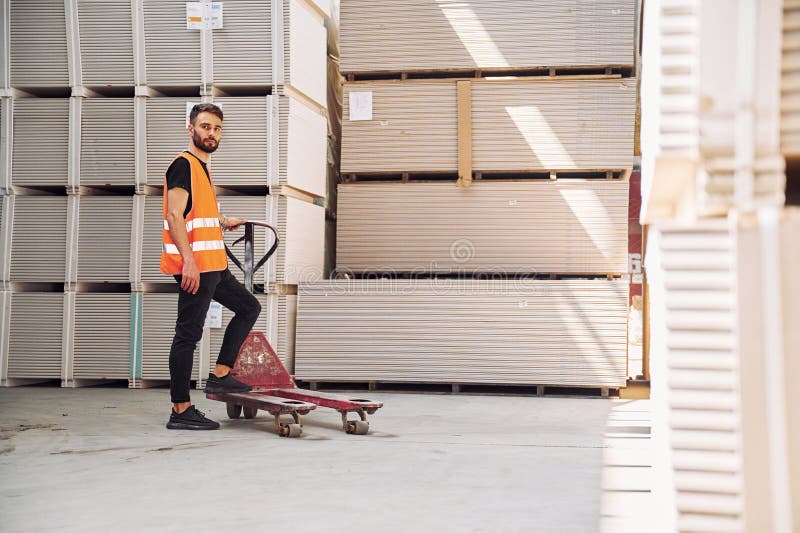 Trolley Platform. Storage Worker is in the Warehouse with Bunch of ...