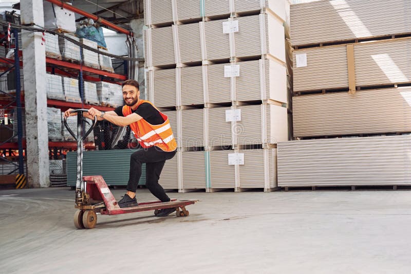 On the Trolley Platform. Storage Worker is in the Warehouse with Bunch ...