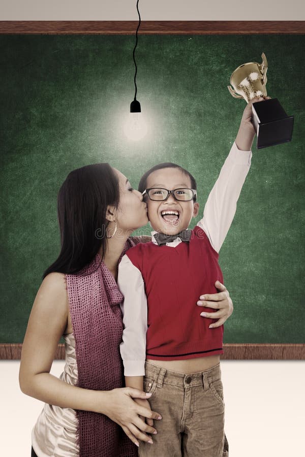 Trophy and Winner Kiss by Mum at Class Stock Photo - Image of school ...