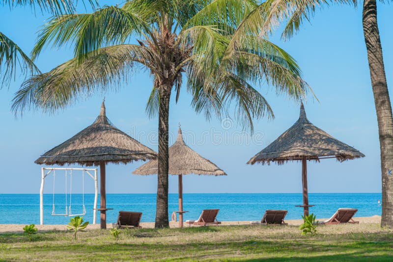 Tropical Beach with Palm Tree and Leaf Umbrellas Stock Photo - Image of ...