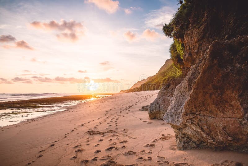 Tropical Beach with Rocks and Sunset or Sunrise Colors Stock Photo ...