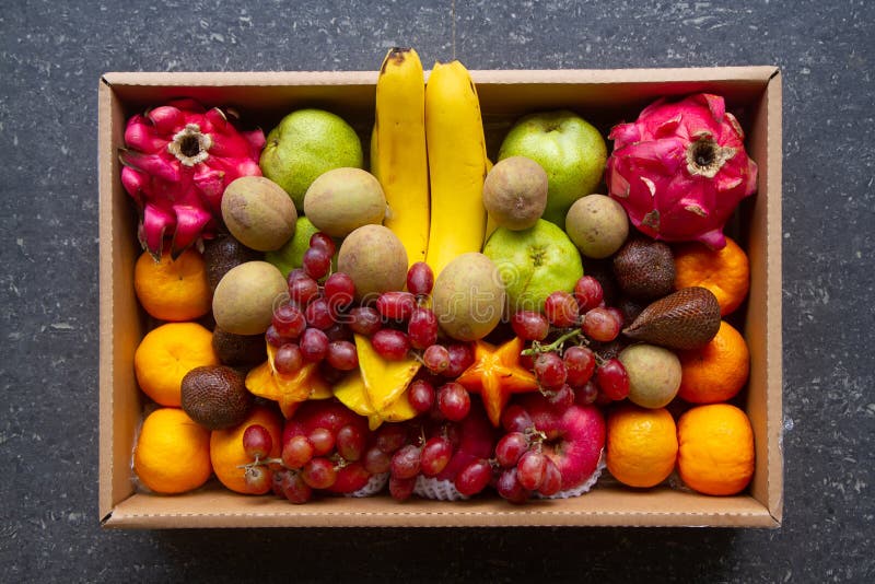 Tropical fruit in a box stock image. Image of banana - 263986545