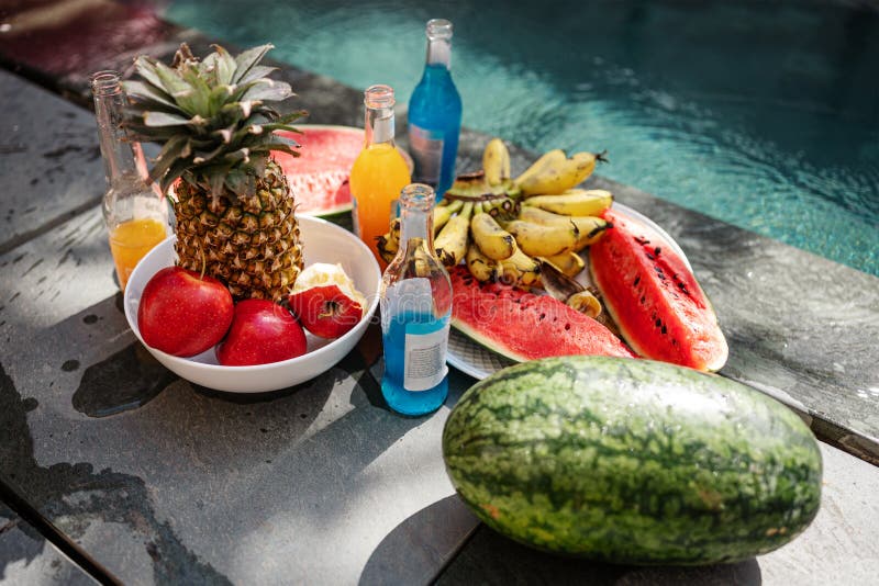 Tropical Fruit and Drinks Next To the Pool. Stock Image - Image of ...