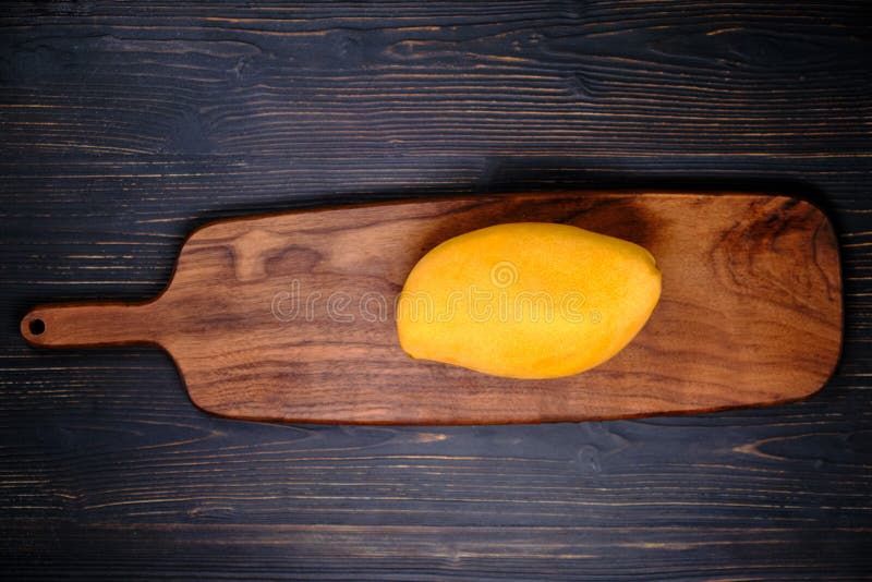 Tropical Fruit on Kitchen Board. Large Mango on a Wooden Table Stock ...