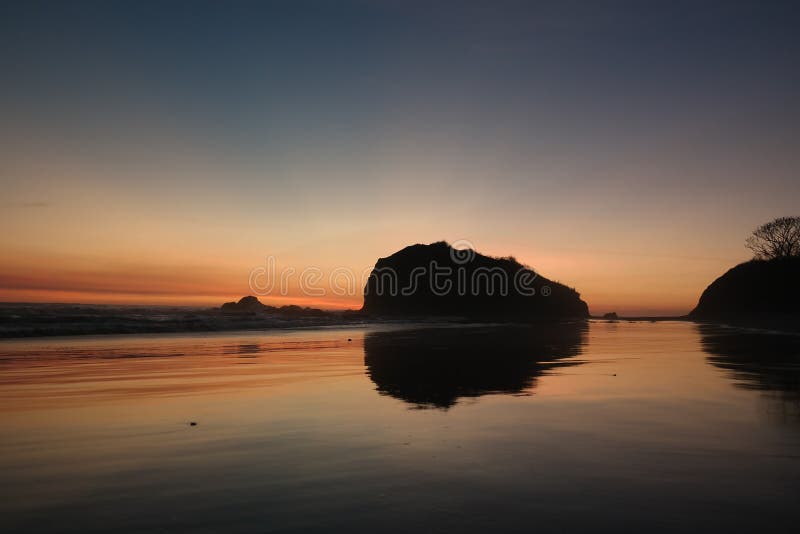 Tropical Ocean Sunset Behind Large Rock Stock Photo - Image of rica ...