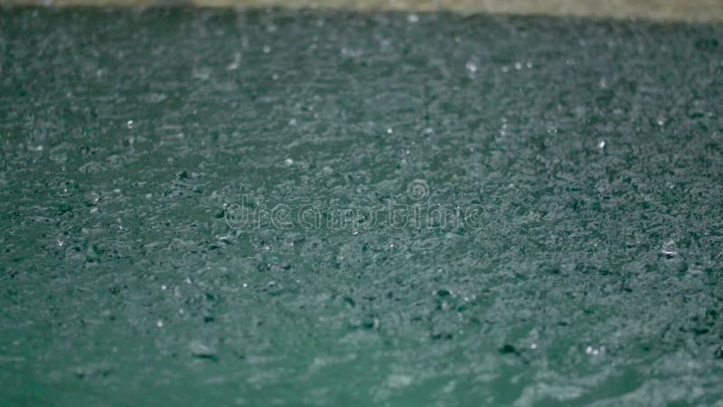Tropical Rain Drops Falling Onto the Surface of a Swimming Pool. Slow ...