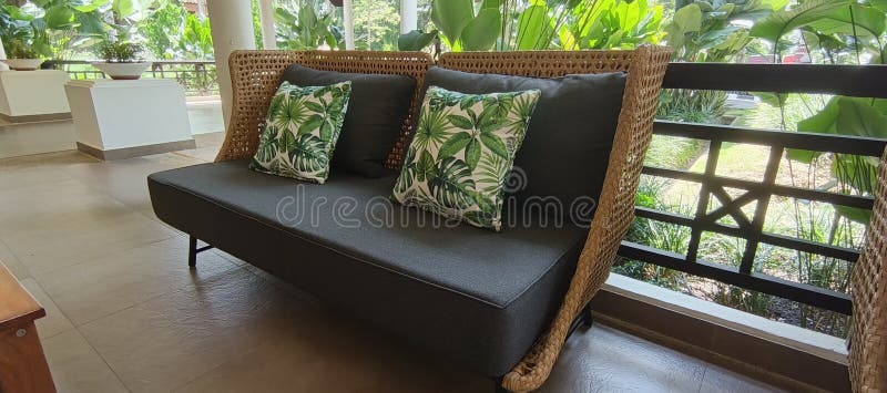 Tropical Rattan Sofa with Leaf Pattern Cushions Stock Image - Image of ...