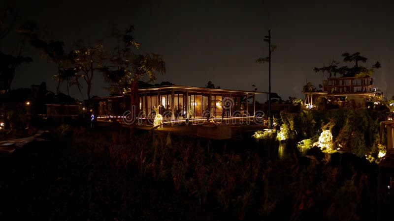 Tropical Resort at Night with Illuminated Bungalow and Palm Trees Stock ...
