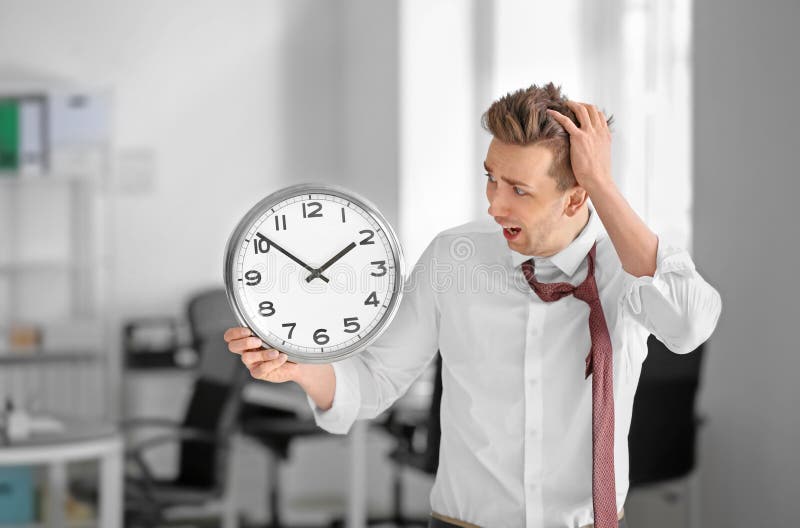 Troubled Businessman with Clock in Office. Time Management Concept ...