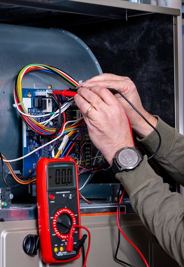 Master Electrician Works on a Furnace Stock Photo - Image of ...
