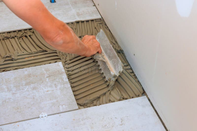 Troweling Adhesive Onto a Concrete Floor in Preparation for Laying ...