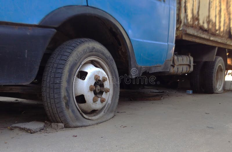 A Truck with a Broken Tire. Stock Photo - Image of tirean, rust: 375081048