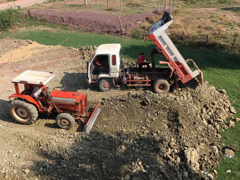 Truck and Bulldozer Dirt Leveling on Plot of Land Stock Image - Image ...