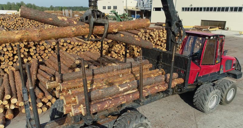 Truck with a Crane Loads Logs, Loading Logs with a Manipulator Stock ...