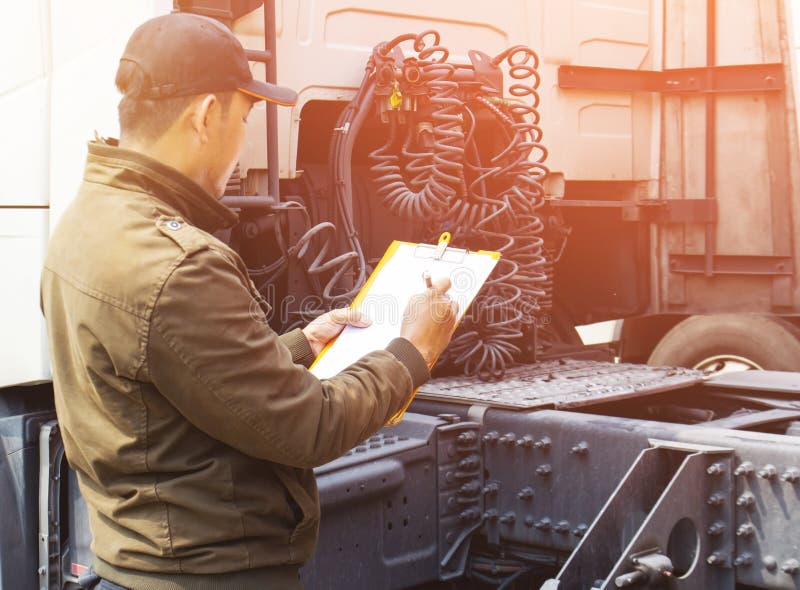Truck Driver is Checking the Truck`s Safety Maintenance Checklist ...