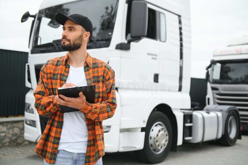Truck Driver Checking Shipment List while Standing on Parking Lot of ...