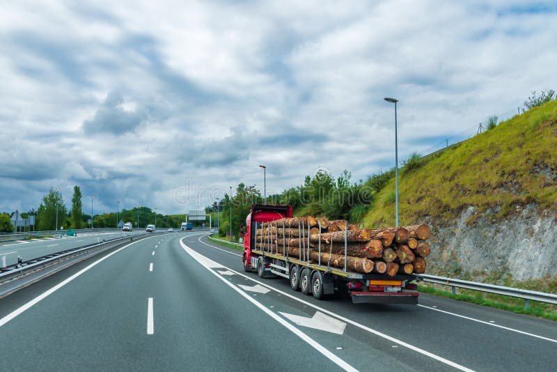 Truck Loaded with Wood Logs Entering a Highway Stock Image - Image of ...
