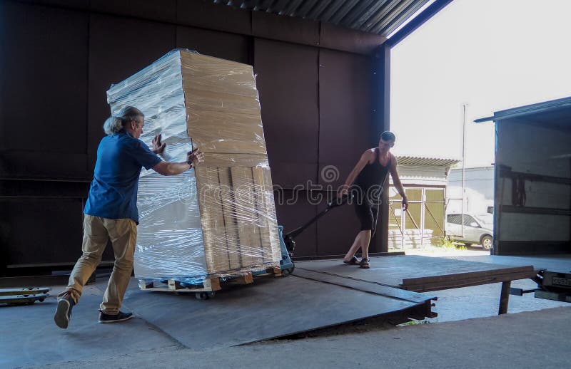 Truck Loading and Shipping. Male Workers are Loading the Goods in ...
