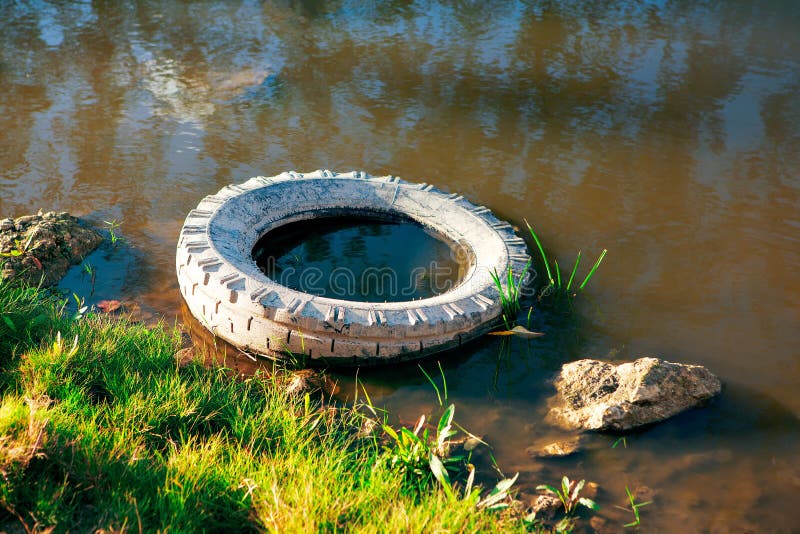 Truck tire in the river stock photo. Image of grunge - 198740518