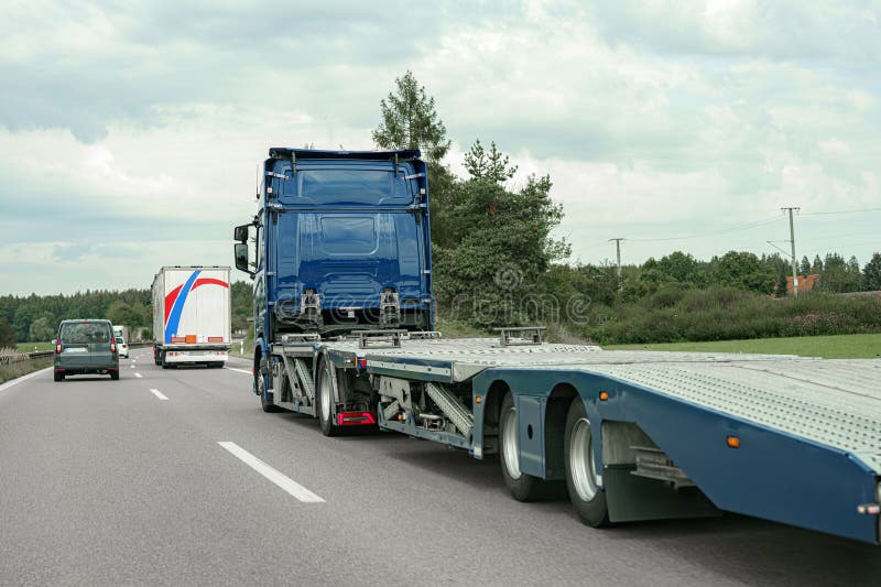 A Truck for Transporting Passenger Cars on the Highway Stock Photo ...