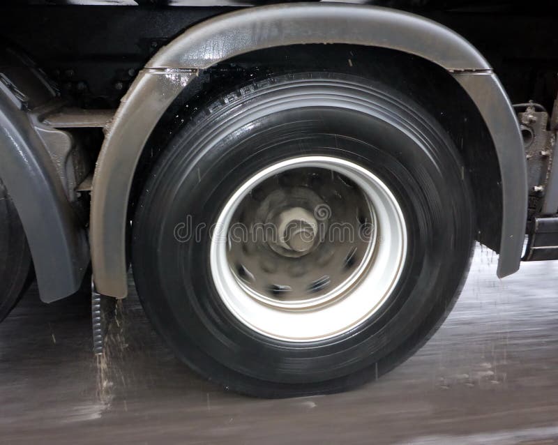 Truck Wheel in Motion on a Wet Road Stock Photo - Image of motion, road ...