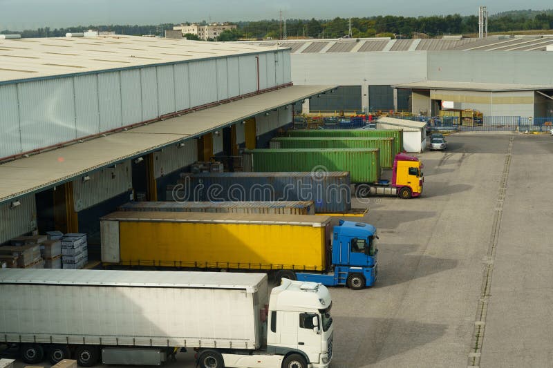 Trucks and Freight Containers at a Busy Cargo Loading Dock during ...