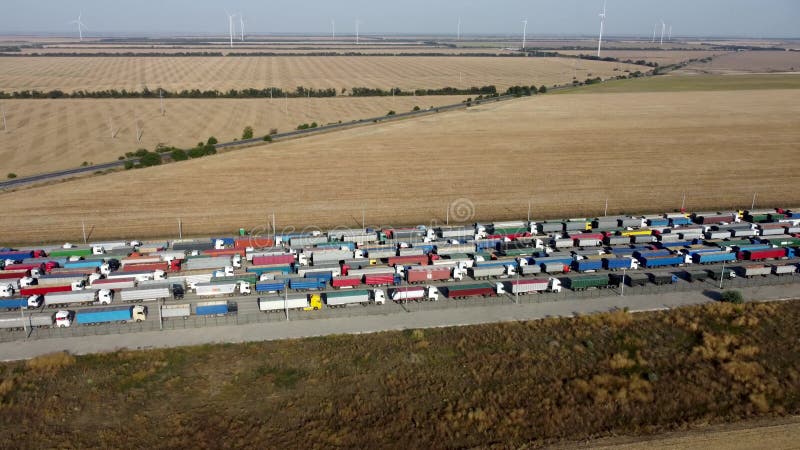 Trucks with Trailers Stand in a Long Queue at the Port Terminal for ...