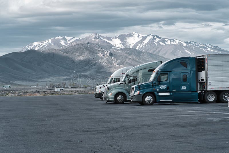 Trucks at a Truck Stop with Mountains in the Background. Editorial ...