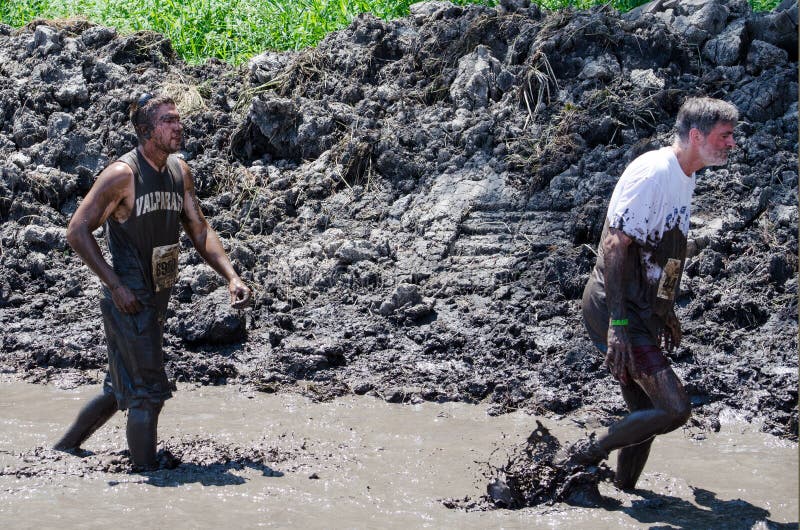 Trudging through mud editorial image. Image of people - 25882470