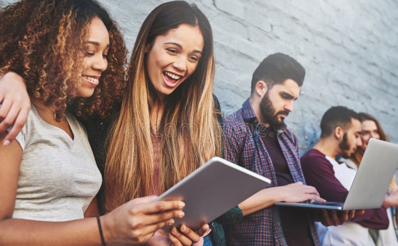 True Friends Share Everything. a Group of Young Friends Using Their ...