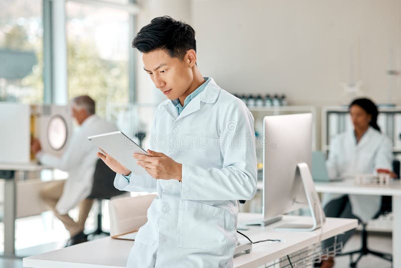 A True Genius at Work. a Young Scientist Using a Digital Tablet in a ...