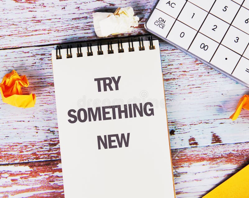 TRY SOMETHING NEW Words on a Blank Sheet of Notepad Located on Old ...
