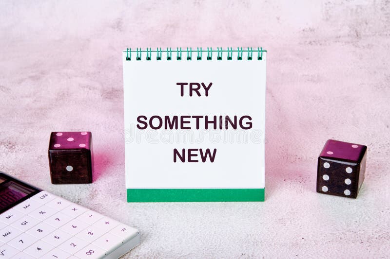 TRY SOMETHING NEW Words on a Notebook Standing Vertically Stock Image ...