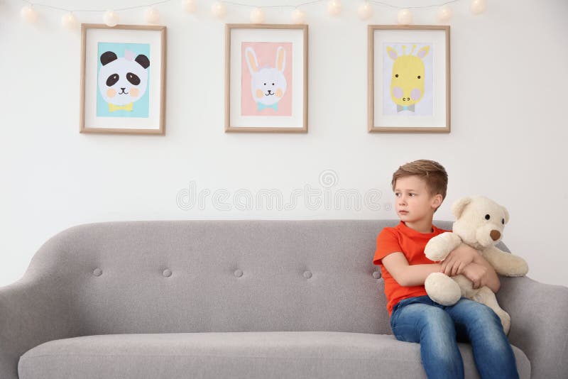 Little Autistic Boy Sitting on Sofa with Toy Stock Image - Image of ...
