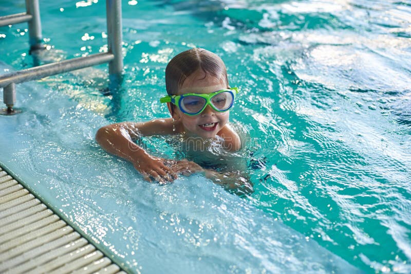 Little Smiling Boy Swims in the Pool. Close-up. Stock Image - Image of ...