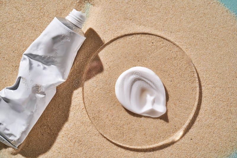 A Tube of Moisturizing Sunscreen and a Smear on a Sandy Background ...