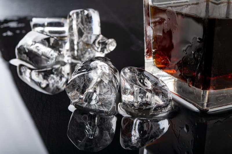 Tube Shaped Ice on a Black Table. Melted Ice Cube on the Kitchen Table ...