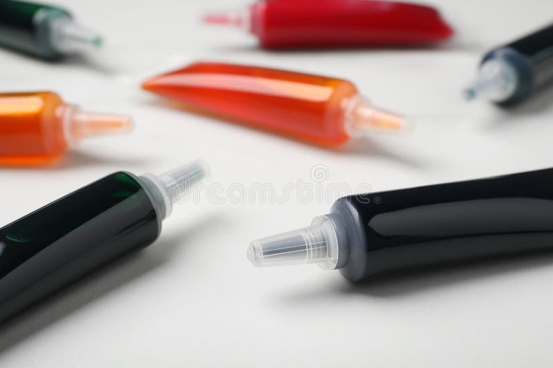 Tubes with Different Food Coloring on White Background, Closeup Stock ...