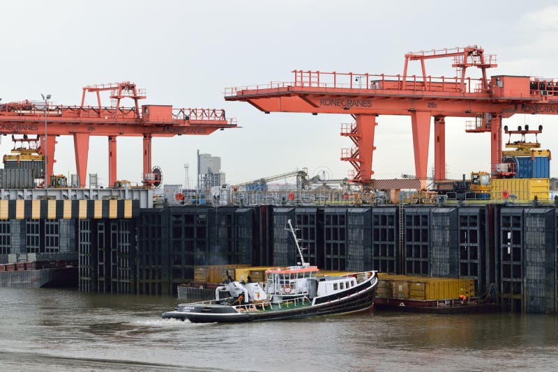 Tug Alongside Pier on River Thames UK with Two Gantry Cranes in ...