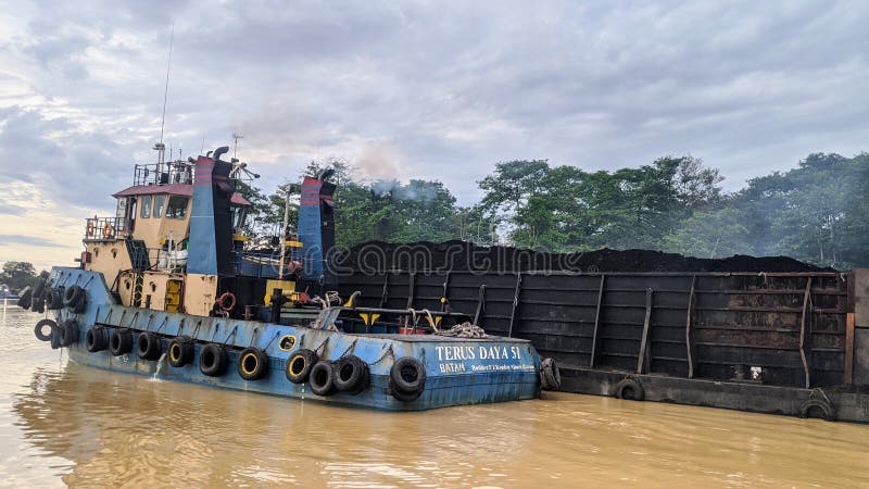 Tug Boat beside a Barge Loaded with Coal on the Batanghari River ...